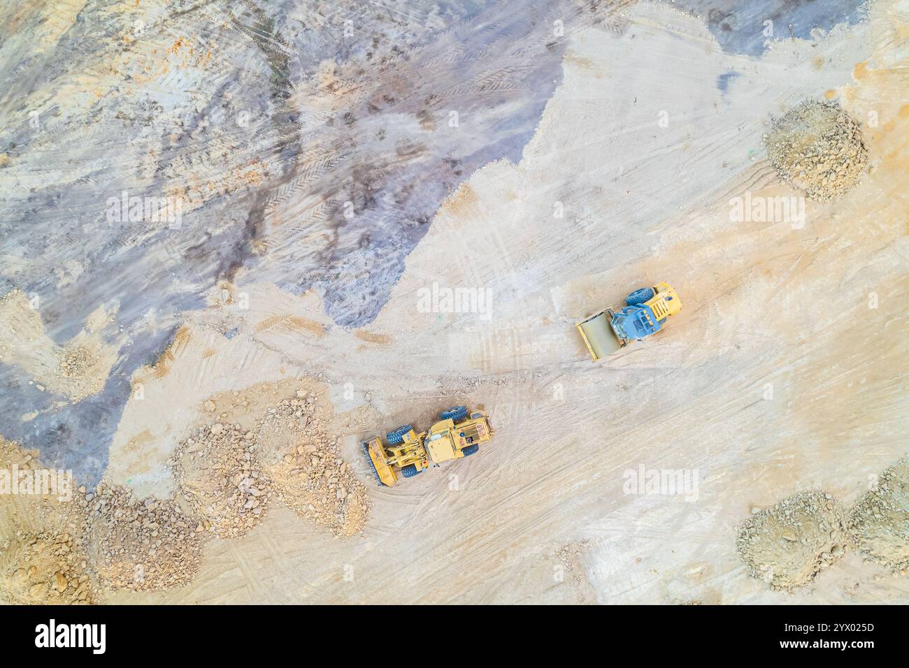 heavy machinery on a construction site, a bulldozer and a steamroller ...