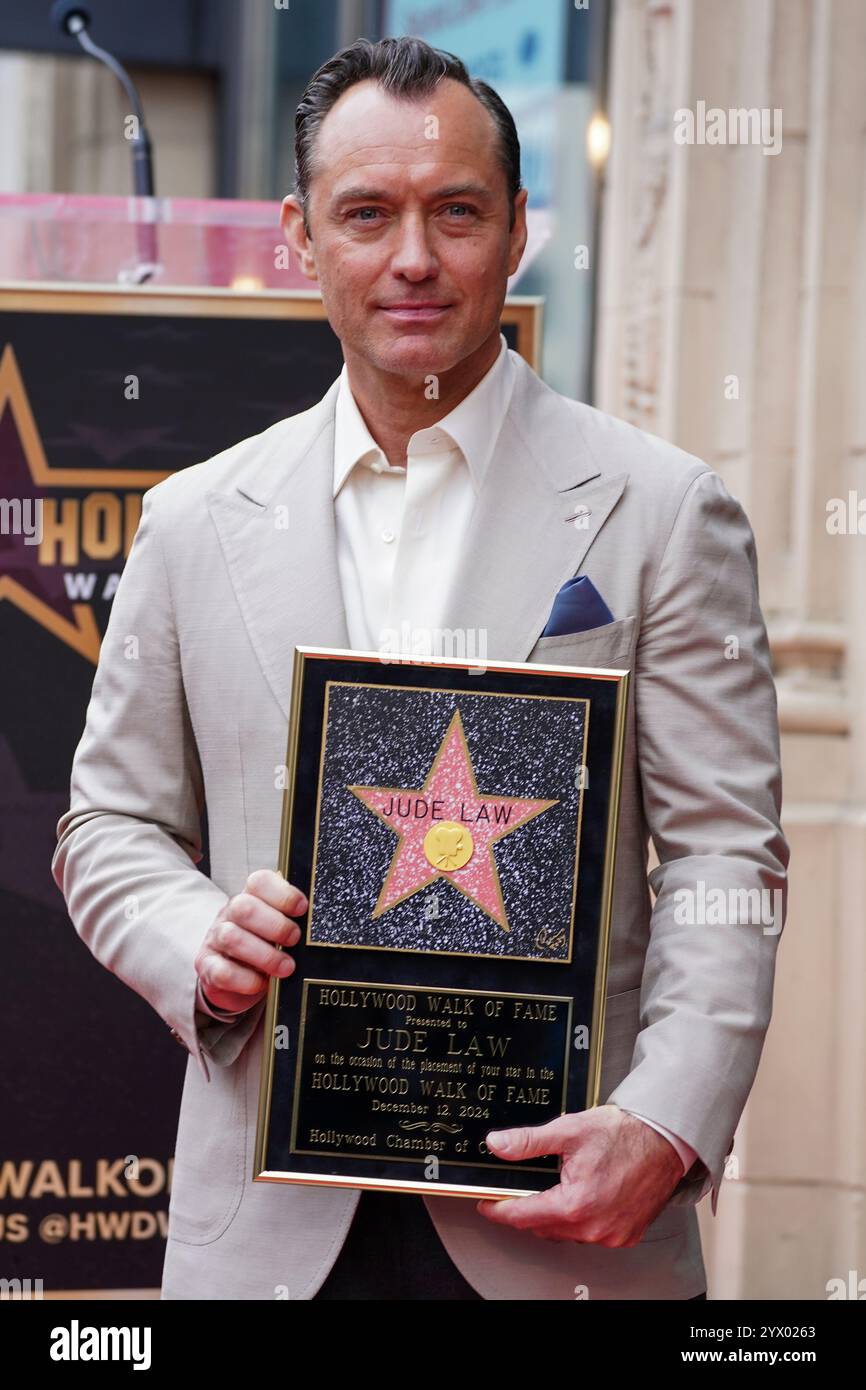 Jude Law poses with his new star at a ceremony honoring him on the ...