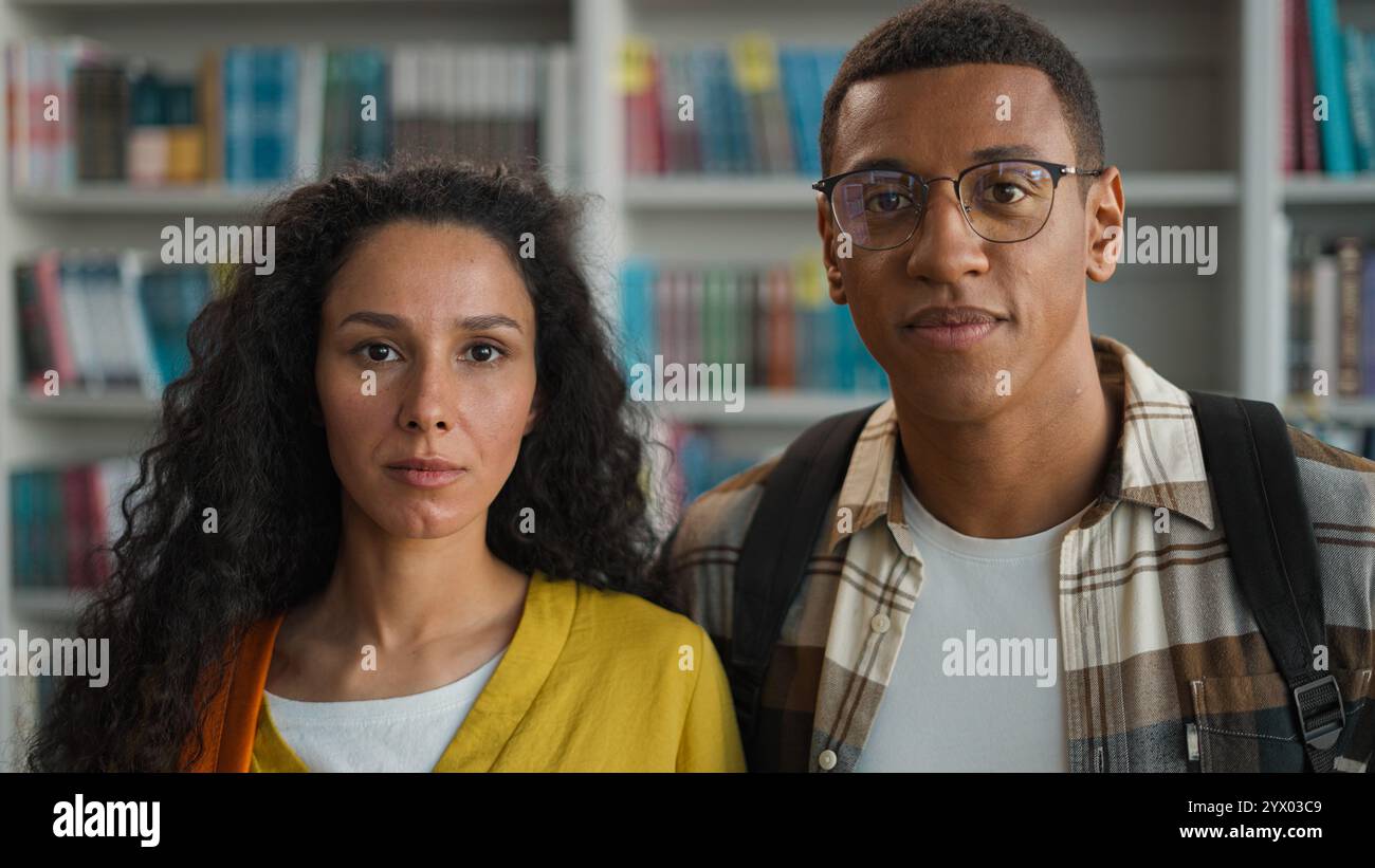 Two students serious African American man Latino Hispanic woman ...