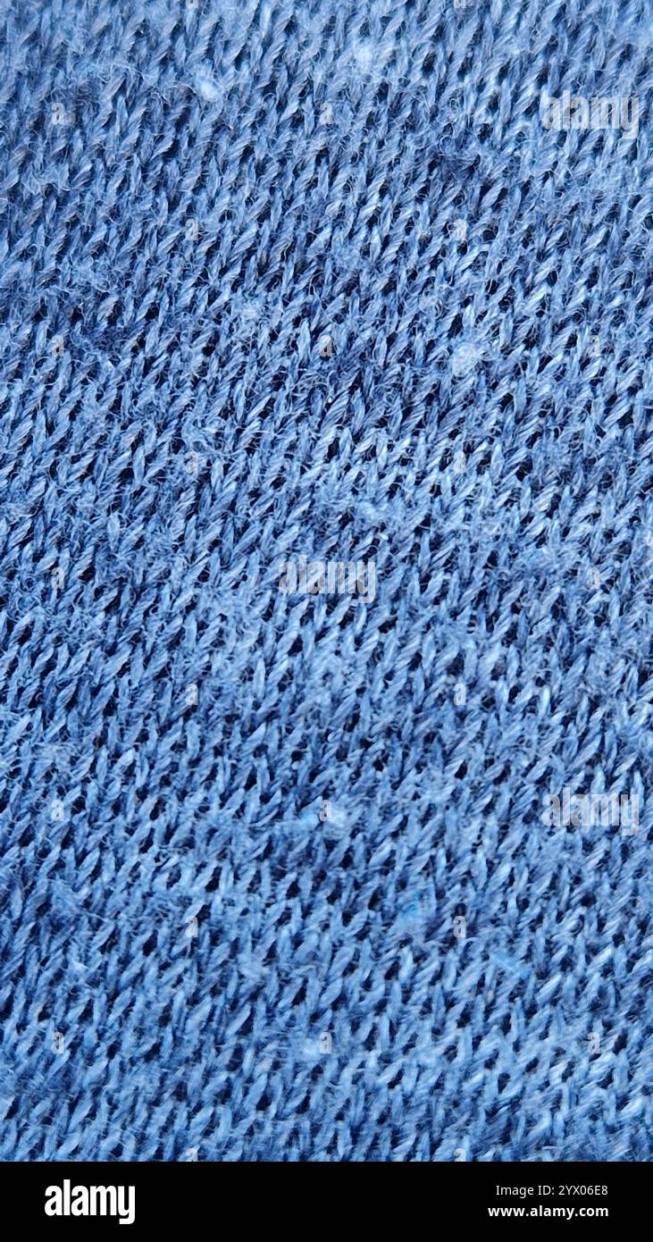 Close-up view of blue knitted fabric showing detailed stitches, texture ...