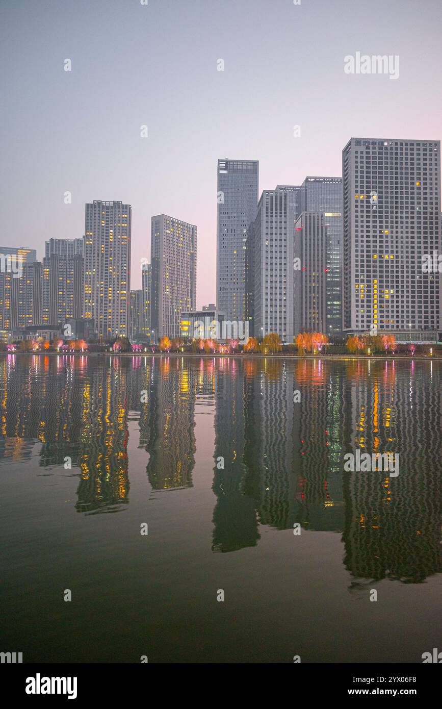 Cityscape at Dusk with Reflections on Water Stock Photo - Alamy