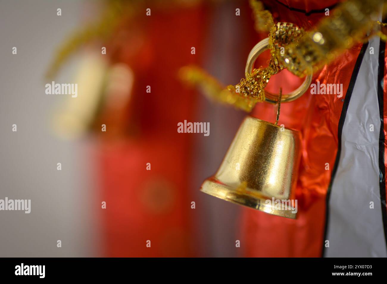 Macro shot of a Christmas bell on the hip of a Santa Claus costume ...