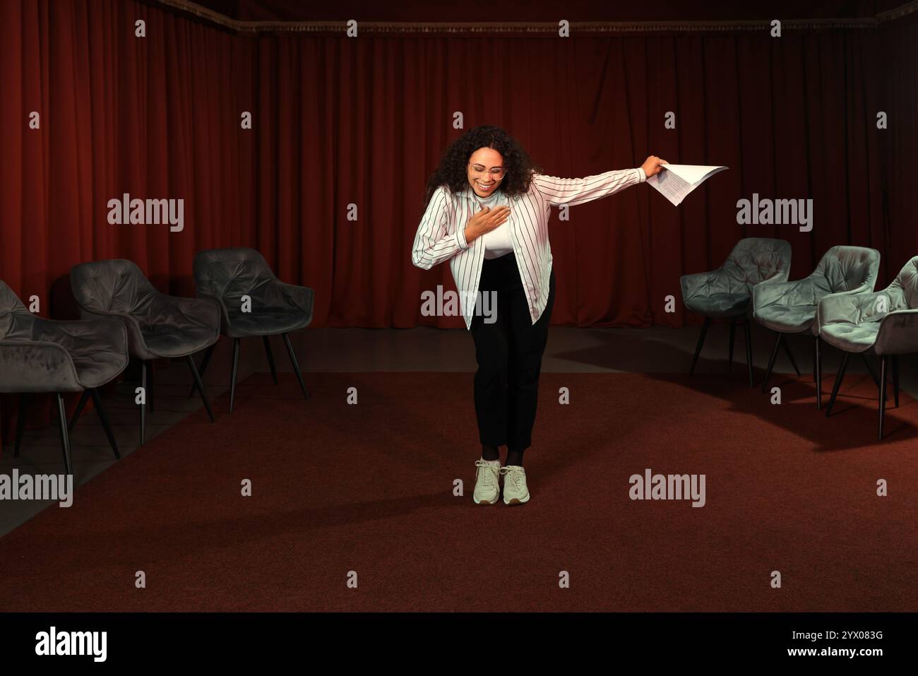 Professional actress bowing on stage in theatre Stock Photo - Alamy