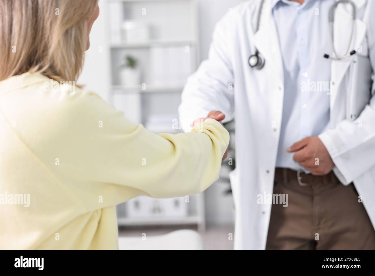 Healthcare worker shaking hands with patient in hospital, closeup Stock ...