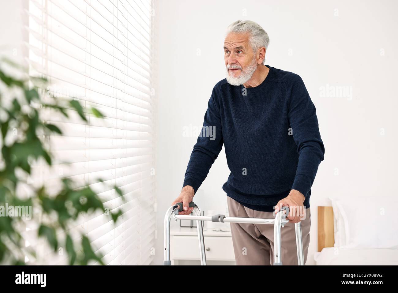 Senior man with walking frame in hospital ward Stock Photo - Alamy