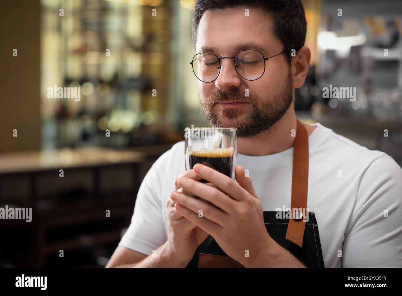 Barista sniffing aromatic filter coffee in cafe Stock Photo - Alamy