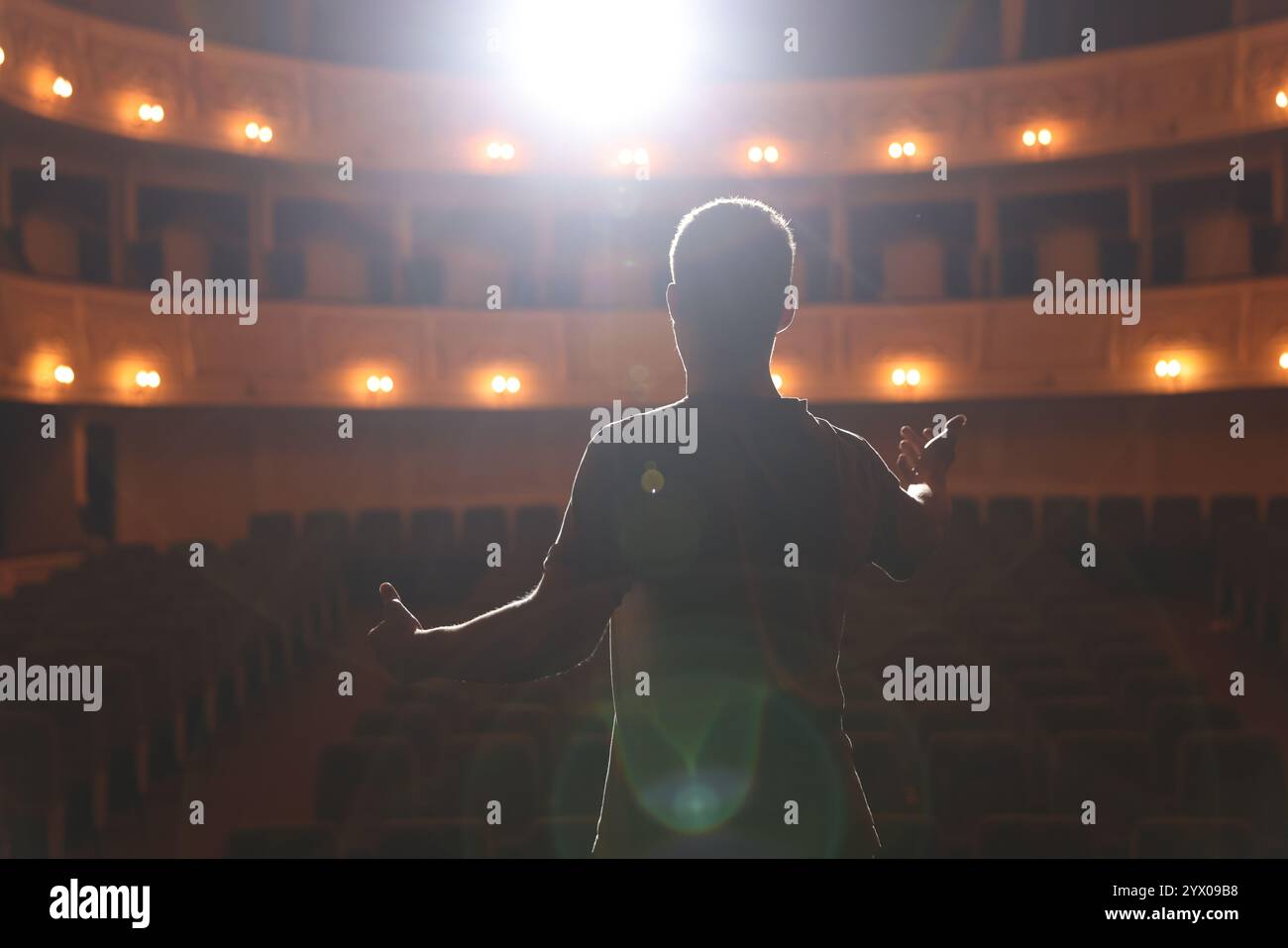 Professional actor rehearsing on stage in theatre, back view Stock ...
