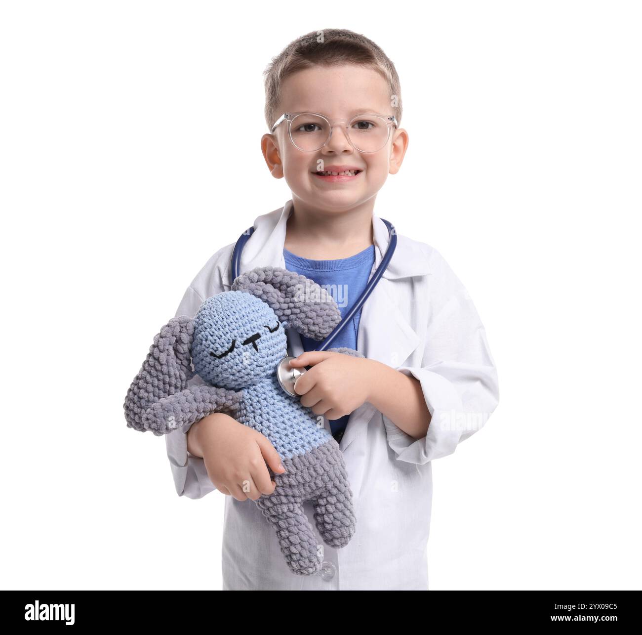 Little boy with stethoscope and toy pretending to be doctor on white ...