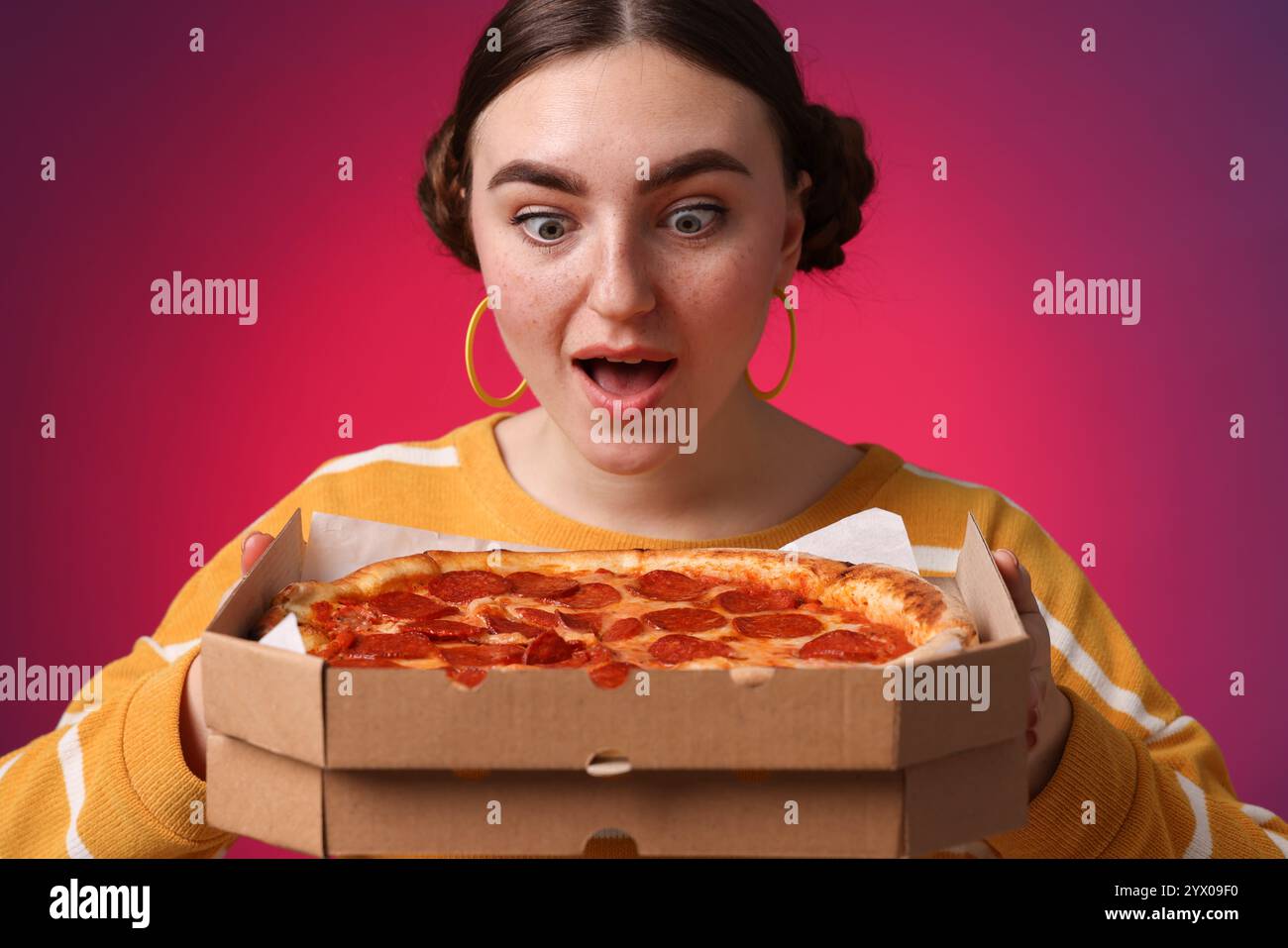 Surprised woman with delicious pizza on bright background Stock Photo ...