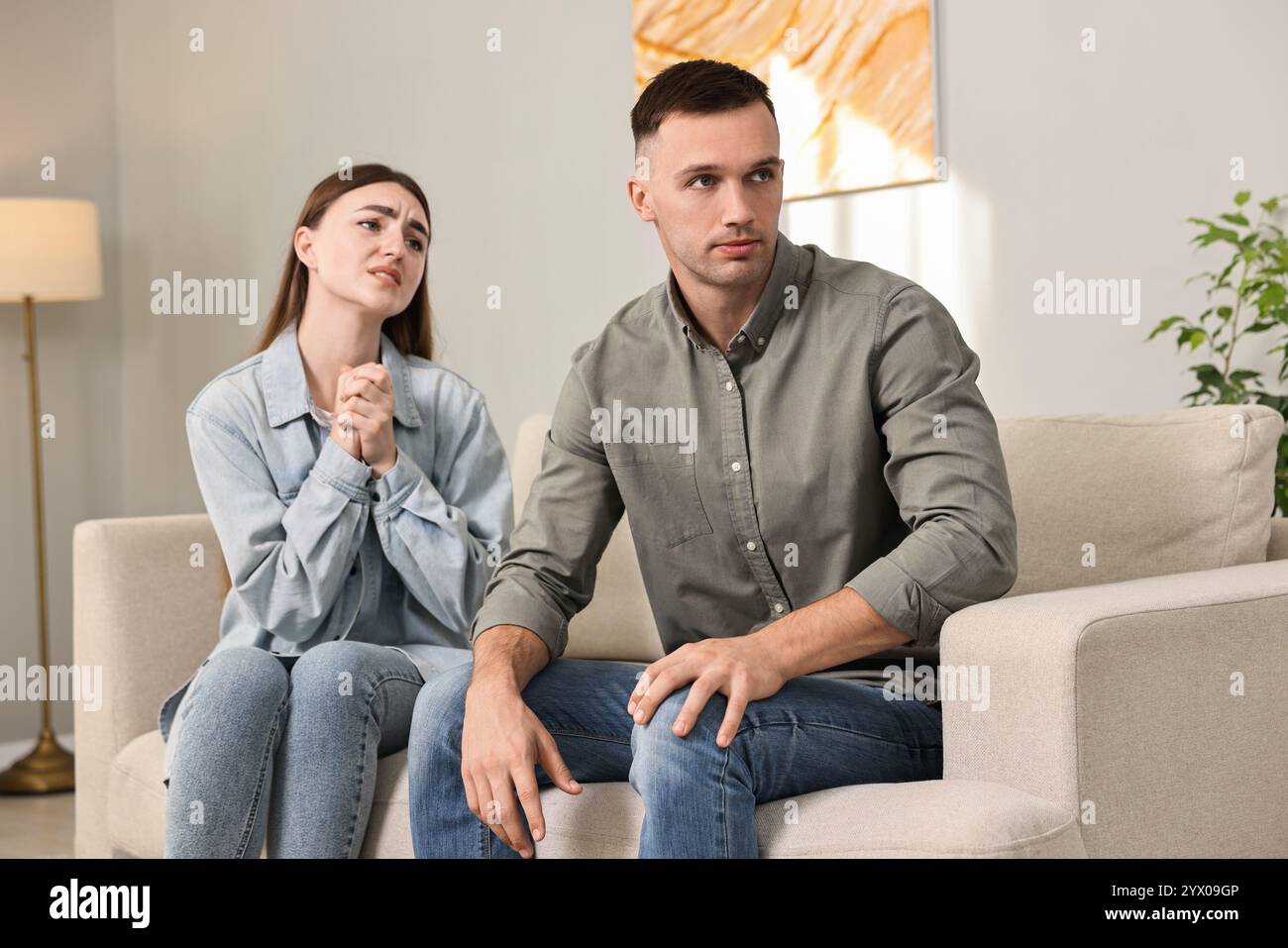 Wife apologizing her husband while he ignoring her at home Stock Photo ...