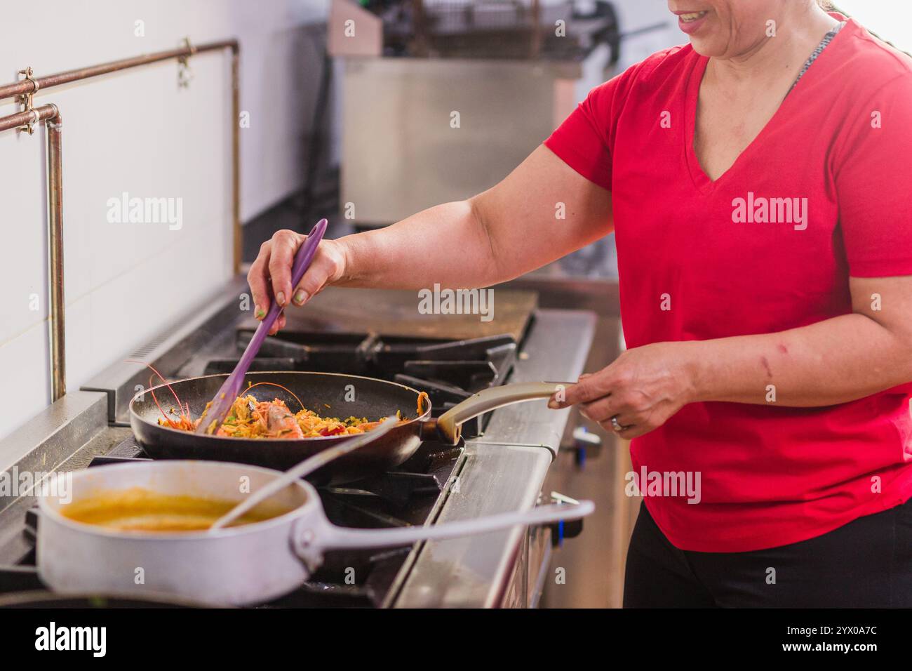 Chef cooking traditional ecuadorian food in restaurant kitchen in ...