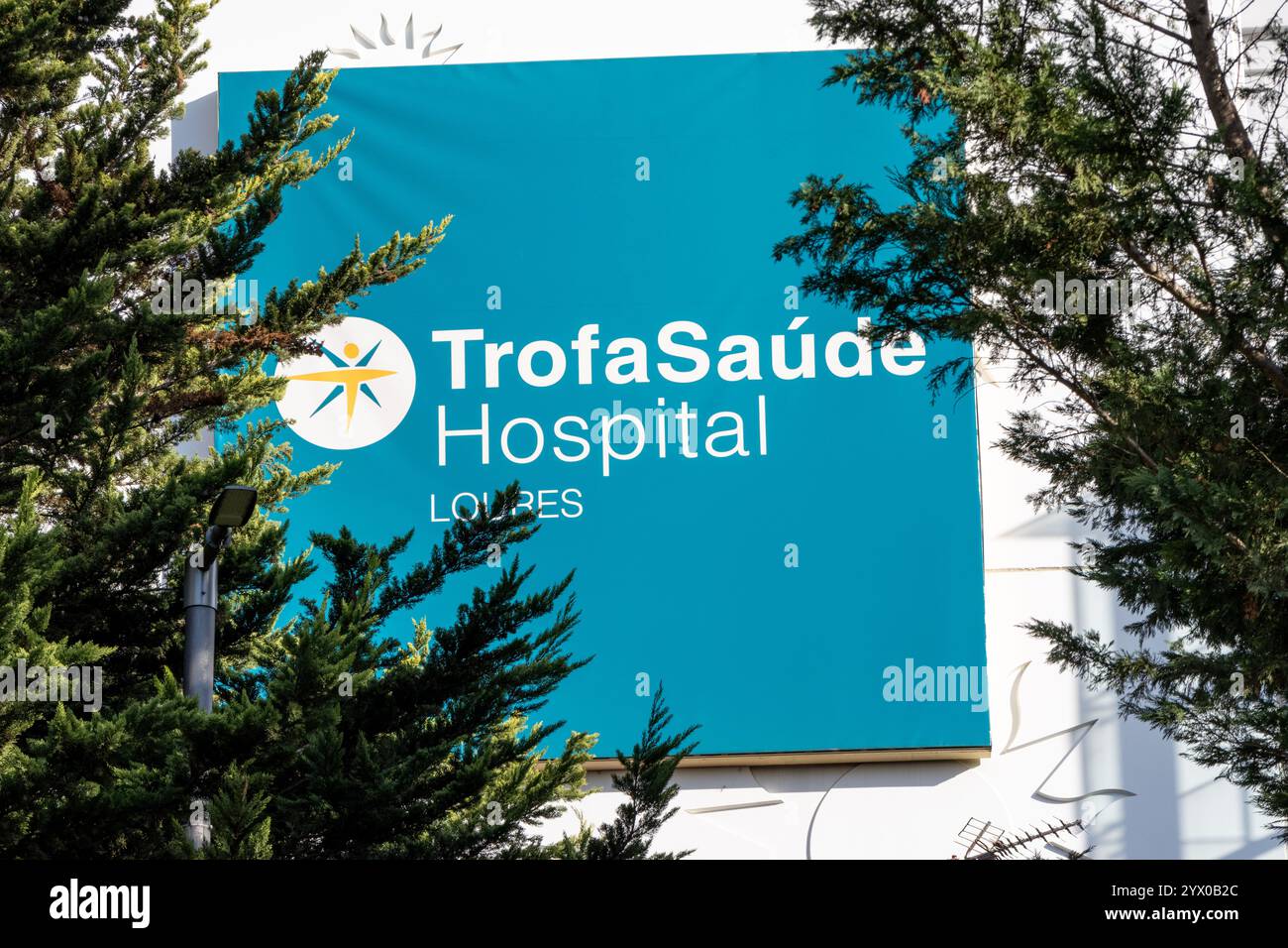 Sunlight illuminating trofa saude hospital sign, partially obscured by ...