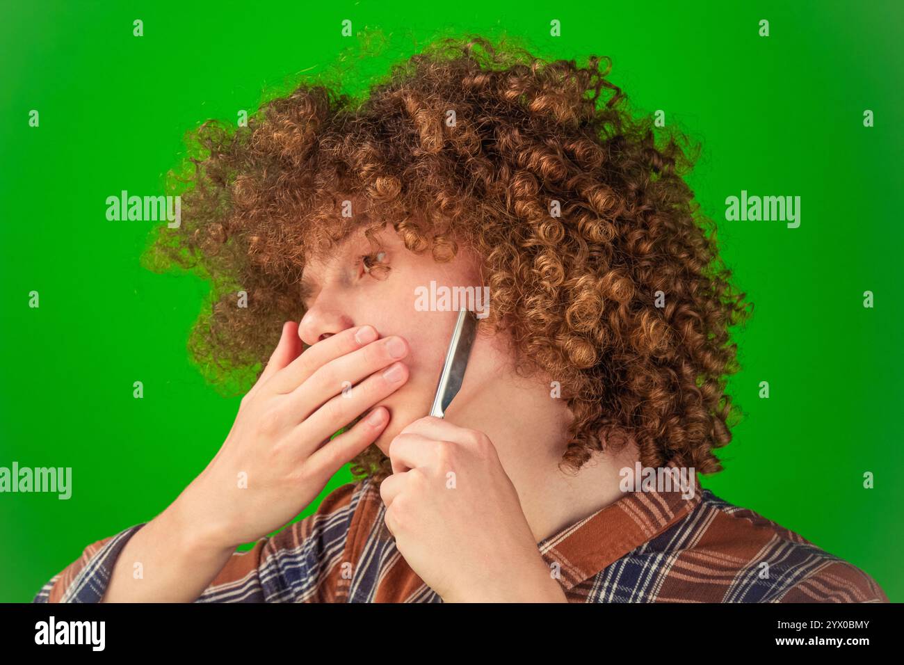 The green chroma key background highlights the boy in a formal shirt as ...