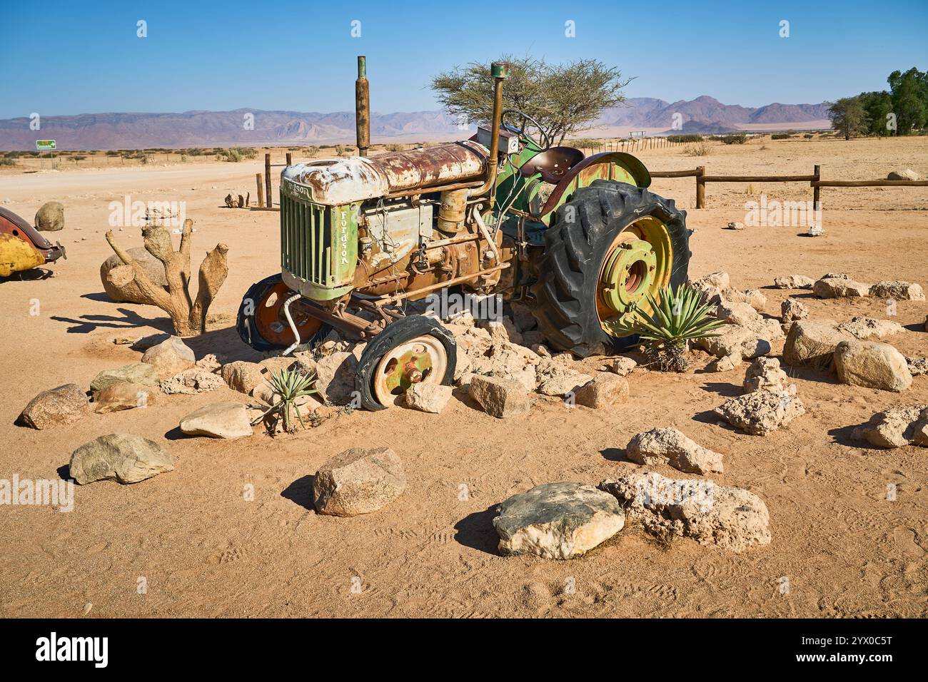 An oldtimer, rusty, demolished and wrecked tractor in Solitare, Namibia ...
