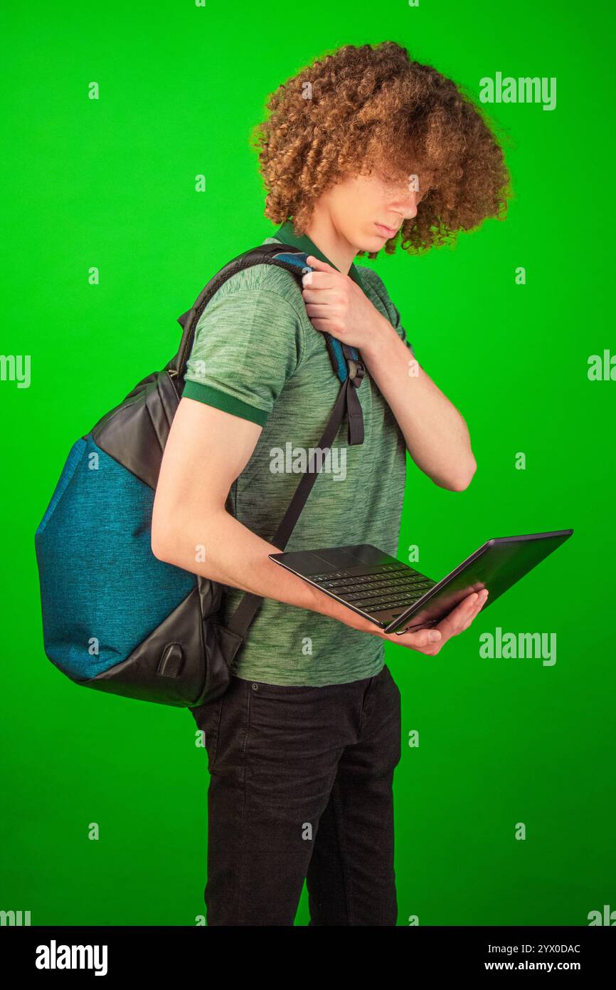 With his laptop securely in hand, the curly-haired man strikes a ...