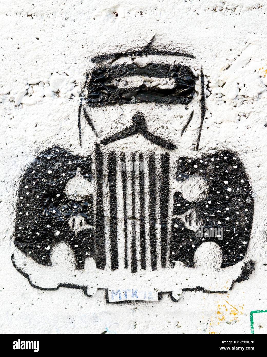 Street graffiti displays old, retro car on white concrete wall Stock ...