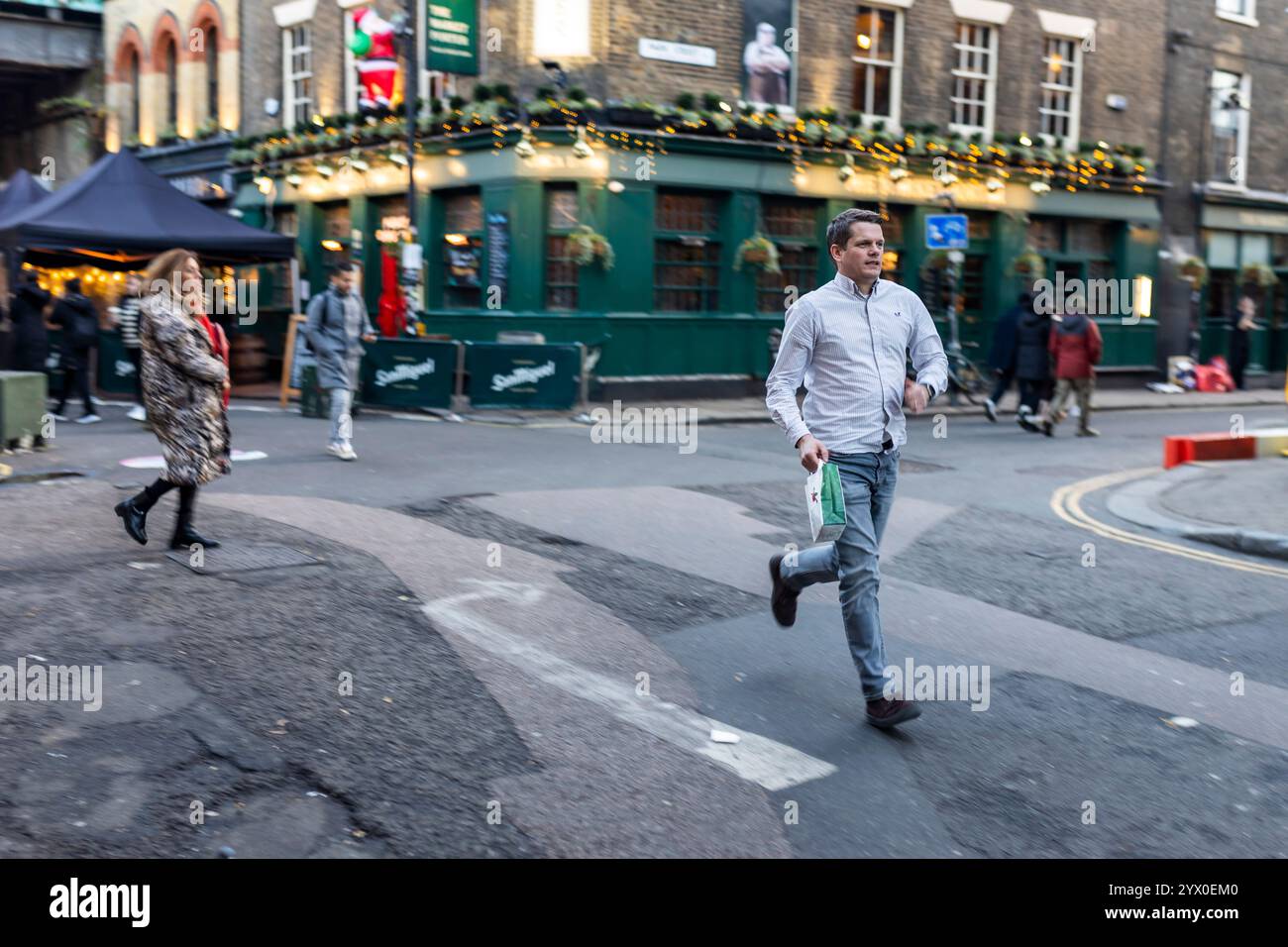 London, UK, December 1, 2024, A young man in jeans and a shirt is ...