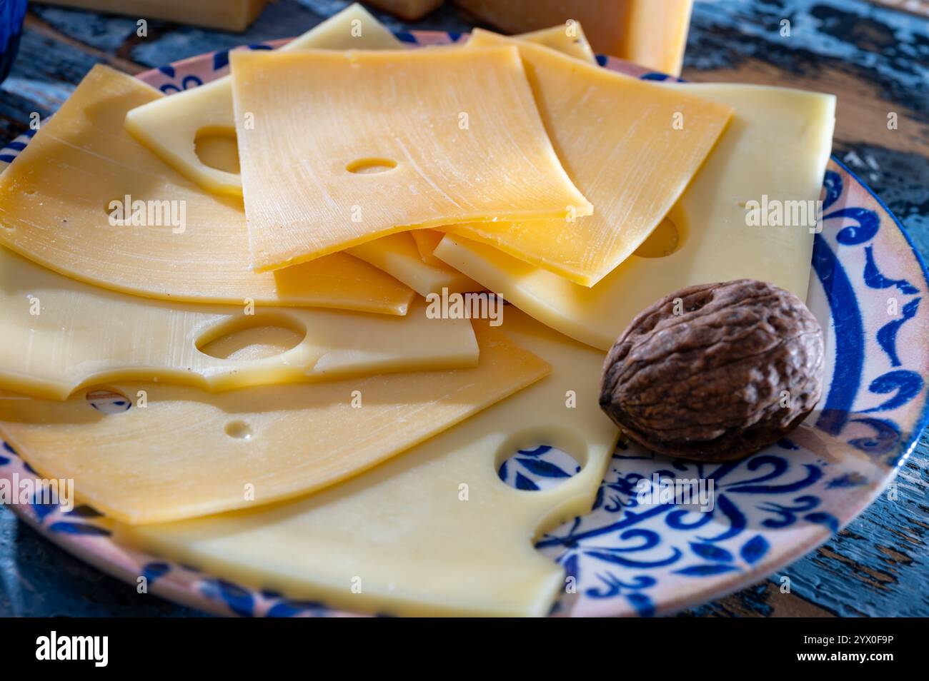 Famous hard cheeses, Dutch Gouda and French Emmentaler in pieces and ...