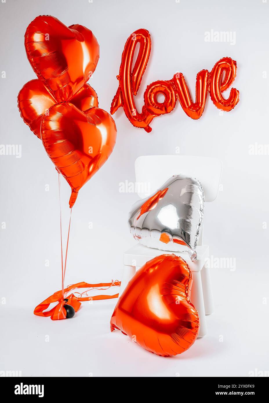 Valentine s Day balloons shaped like hearts with the word Love written ...