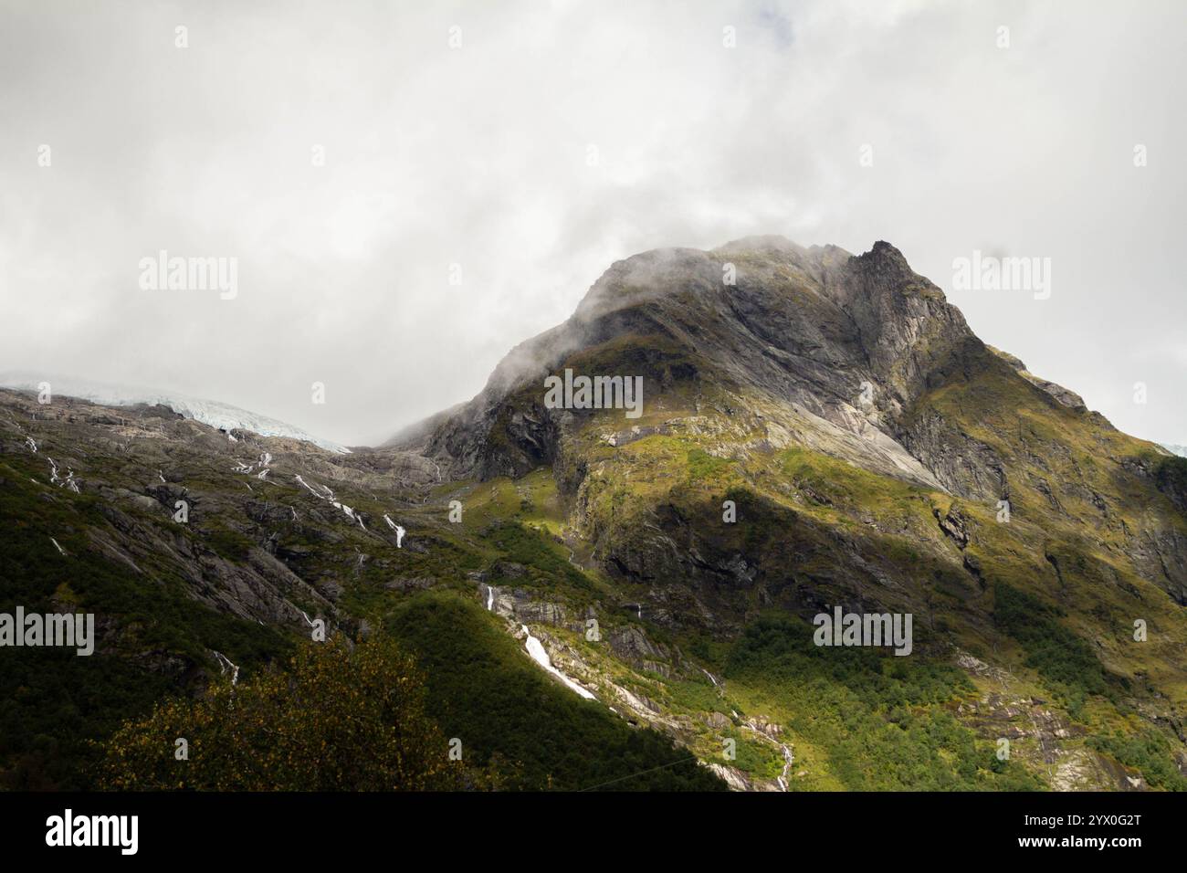 The mountains rise majestically in September, their green slopes and ...