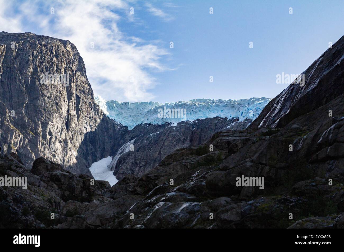 A stunning glacier stretches across the rugged mountain, its icy ...