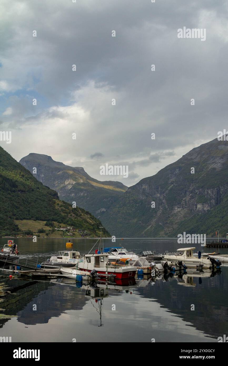Boats gently glide across the serene waters of Geirangerfjord ...