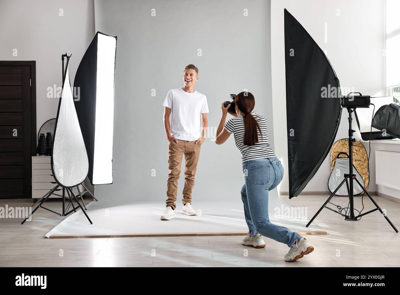 Photographer working with model in professional photo studio Stock ...