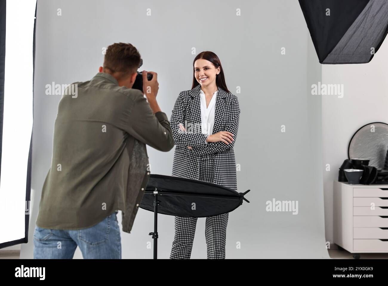 Photographer working with model in professional photo studio Stock ...