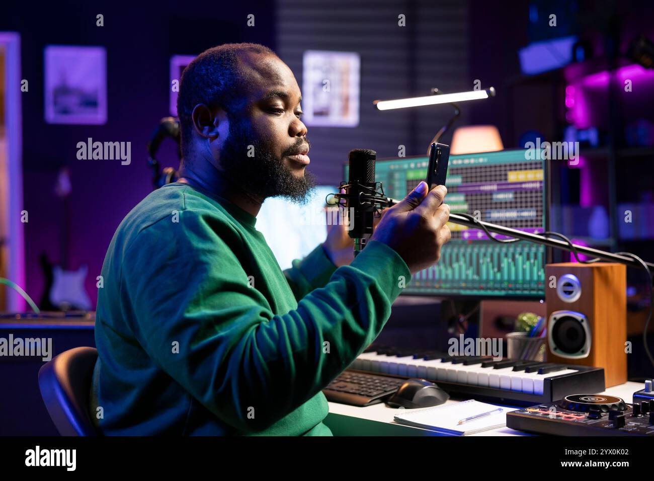 African american producer singer recording audio of his track, adding ...