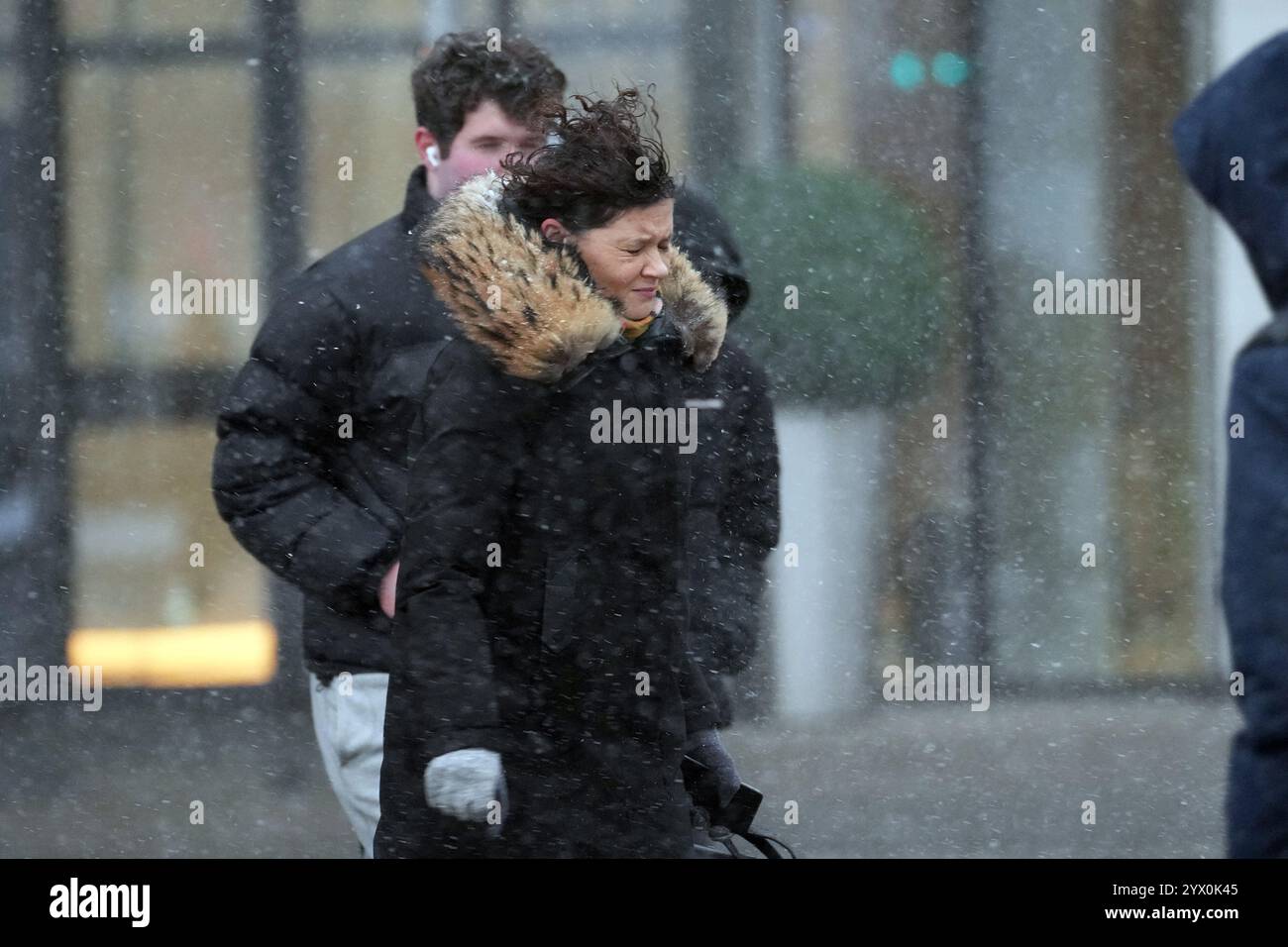 Riga, Latvia. 12th Dec, 2024. Pedestrians walk in the snow in Riga ...