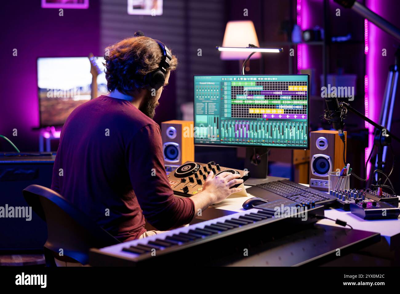 Skilled producer mixing and mastering sounds on stereo console ...