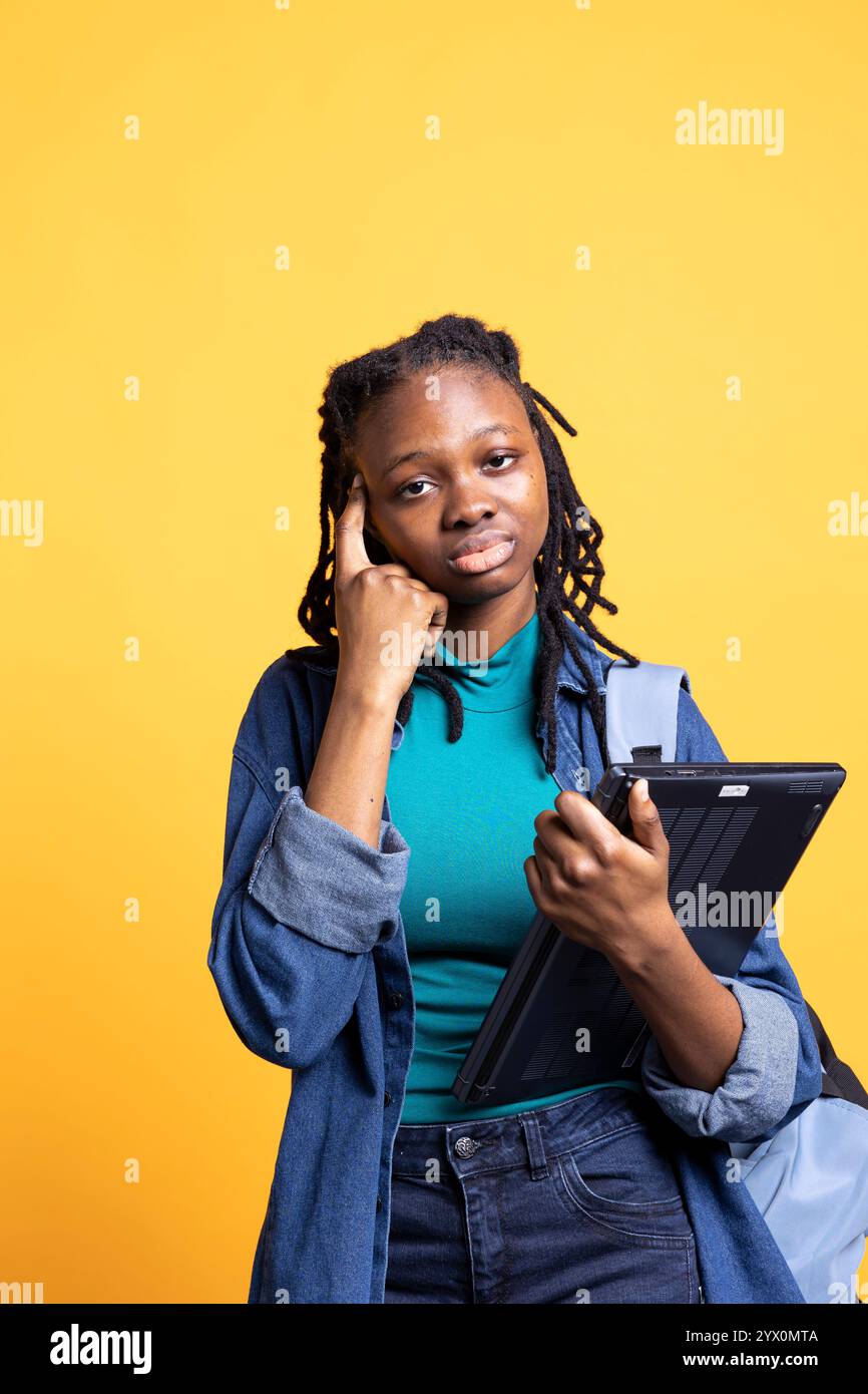 Portrait of BIPOC pensive woman carrying laptop, coming up with idea ...