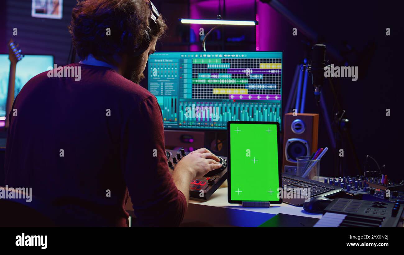 Music producer songwriter mixing tunes on stereo console, recording ...