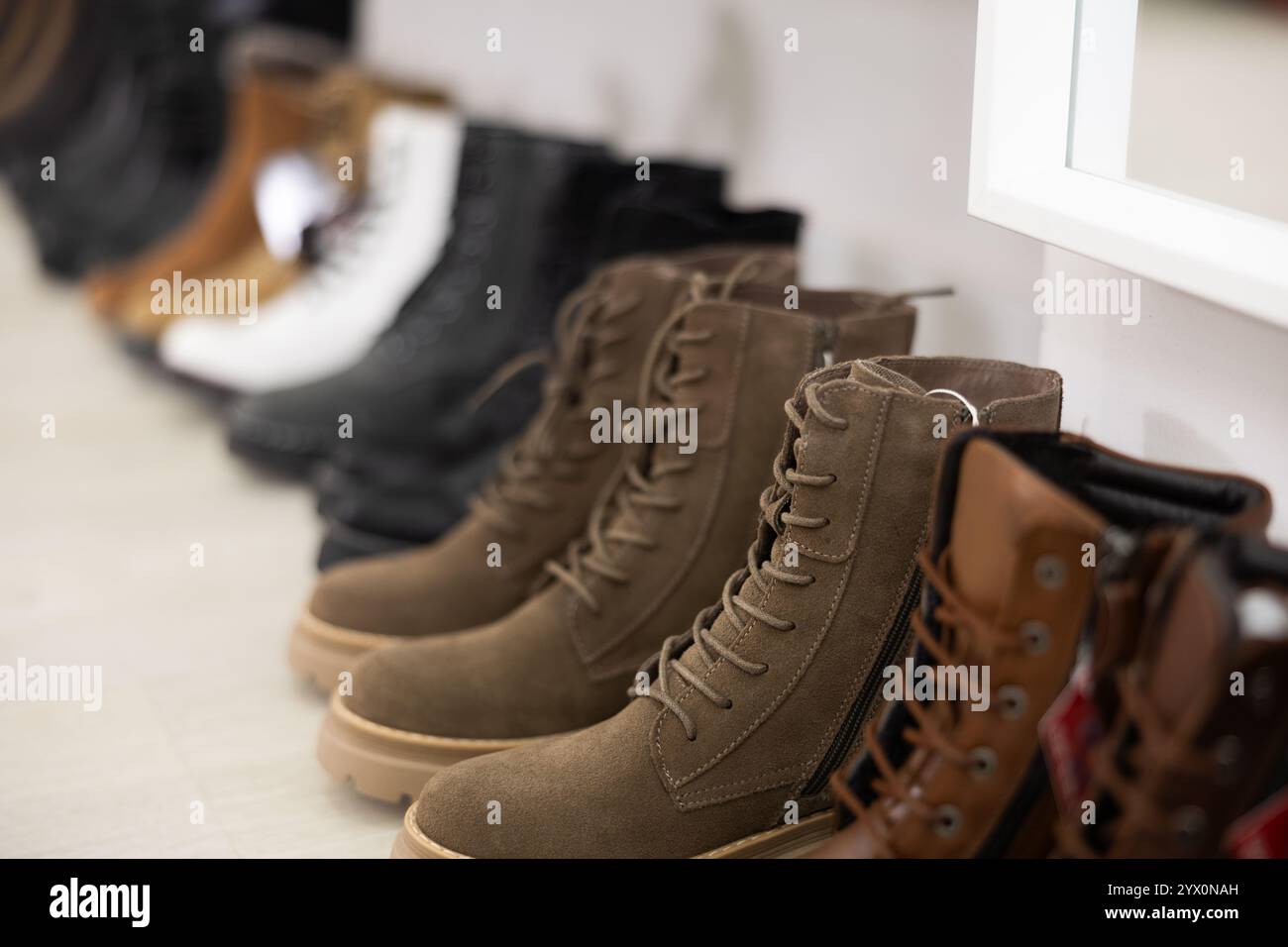 Women's boots displayed on counter in store Stock Photo - Alamy