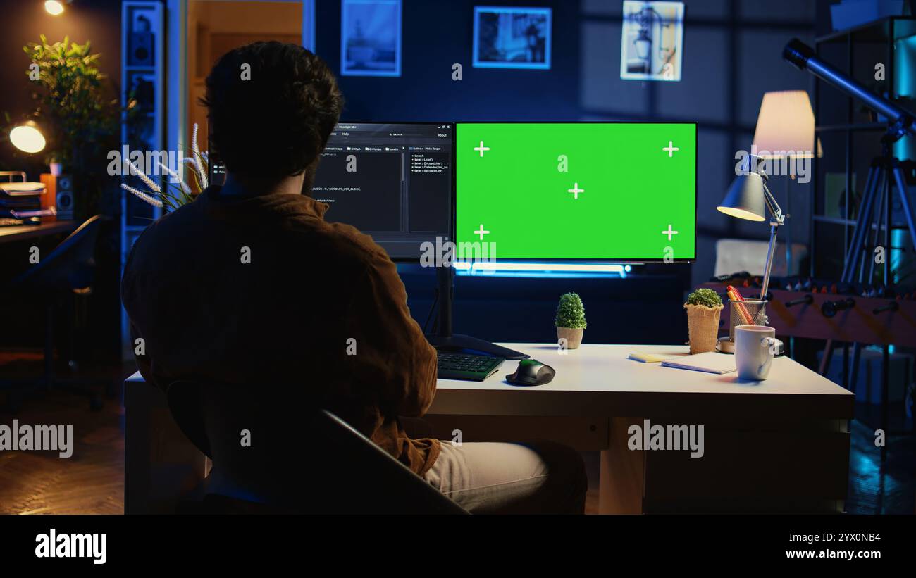 Self employed man doing IT support job from apartment personal office, coding on green screen PC ...