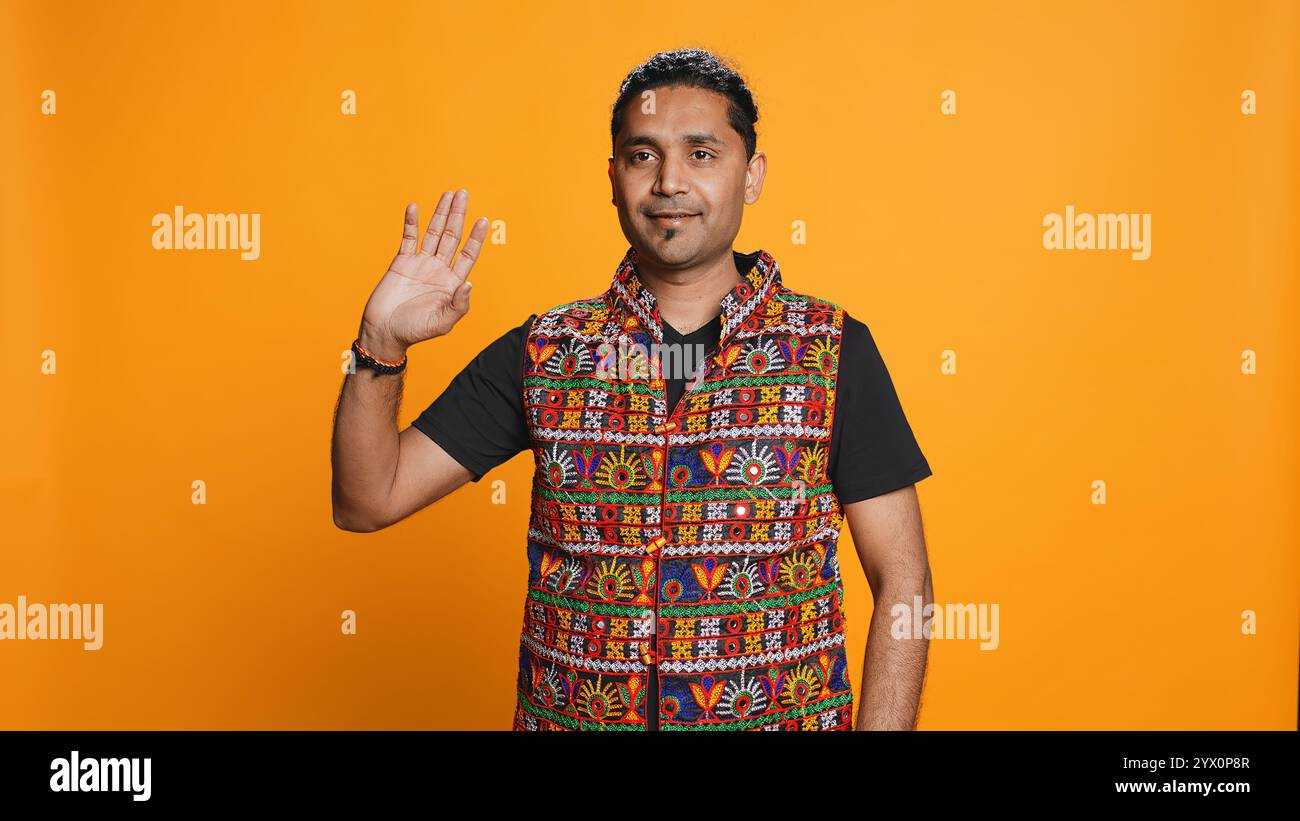 Portrait of happy man waving hand, saluting, gesturing, isolated over ...