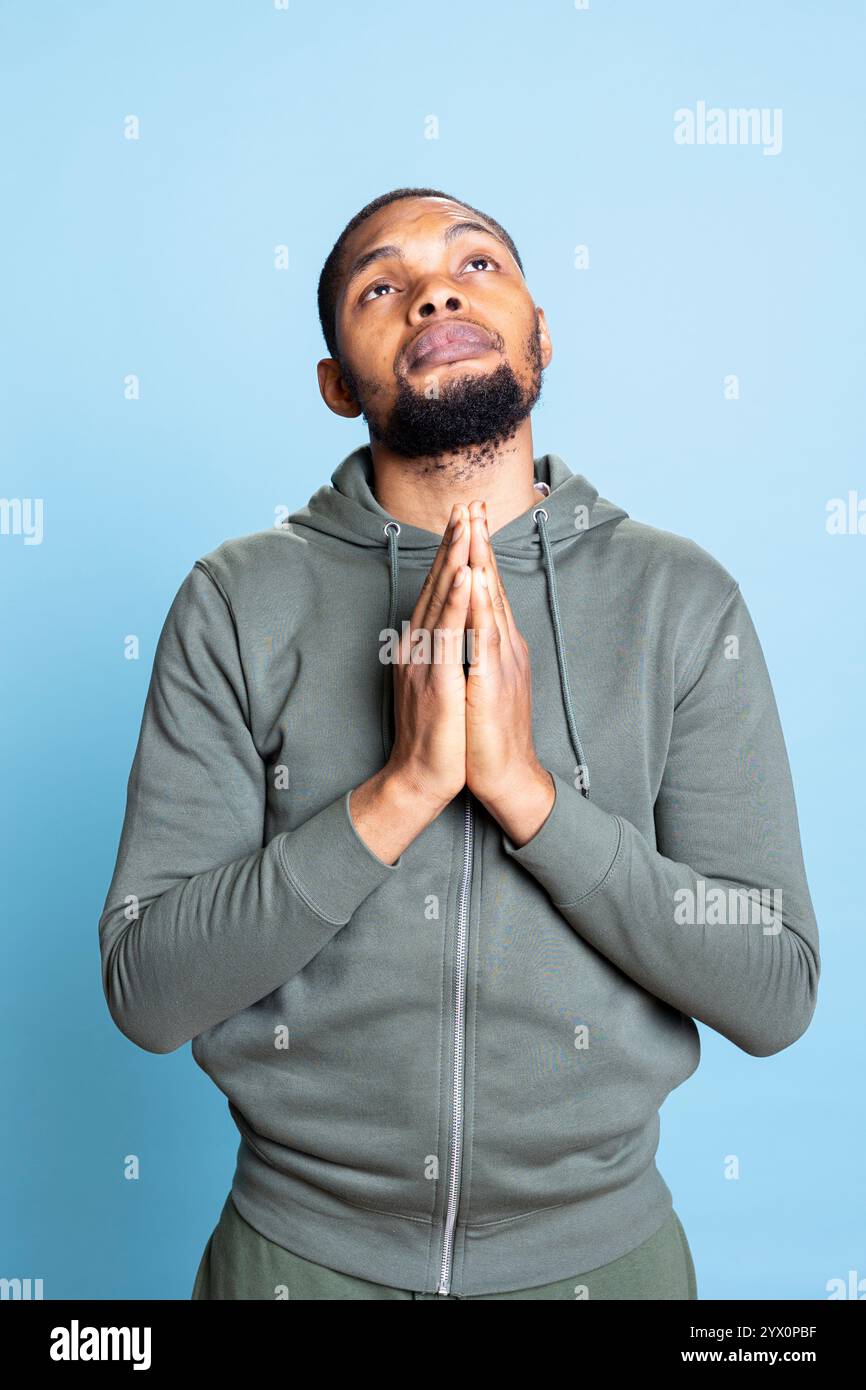 African american spiritual guy holding hands in a prayer and asking for ...