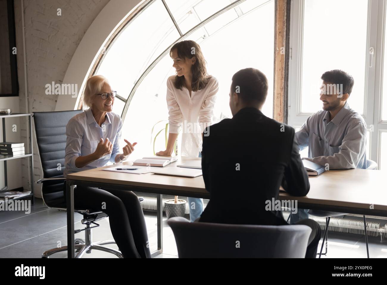Group of positive teammates take part in briefing Stock Photo - Alamy