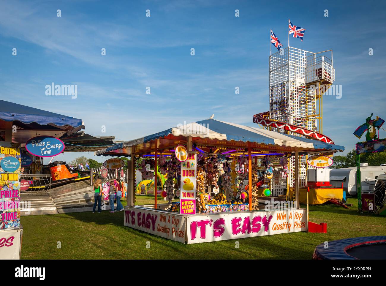 British carnival fairground festival with prize booths, games, waltzer ...
