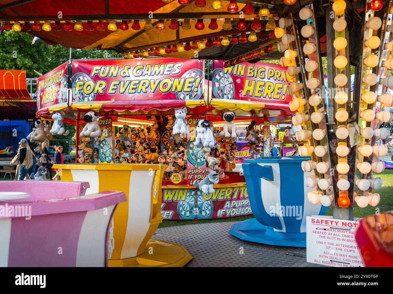 Close up of teacups merry go round ride and prize booth at British ...