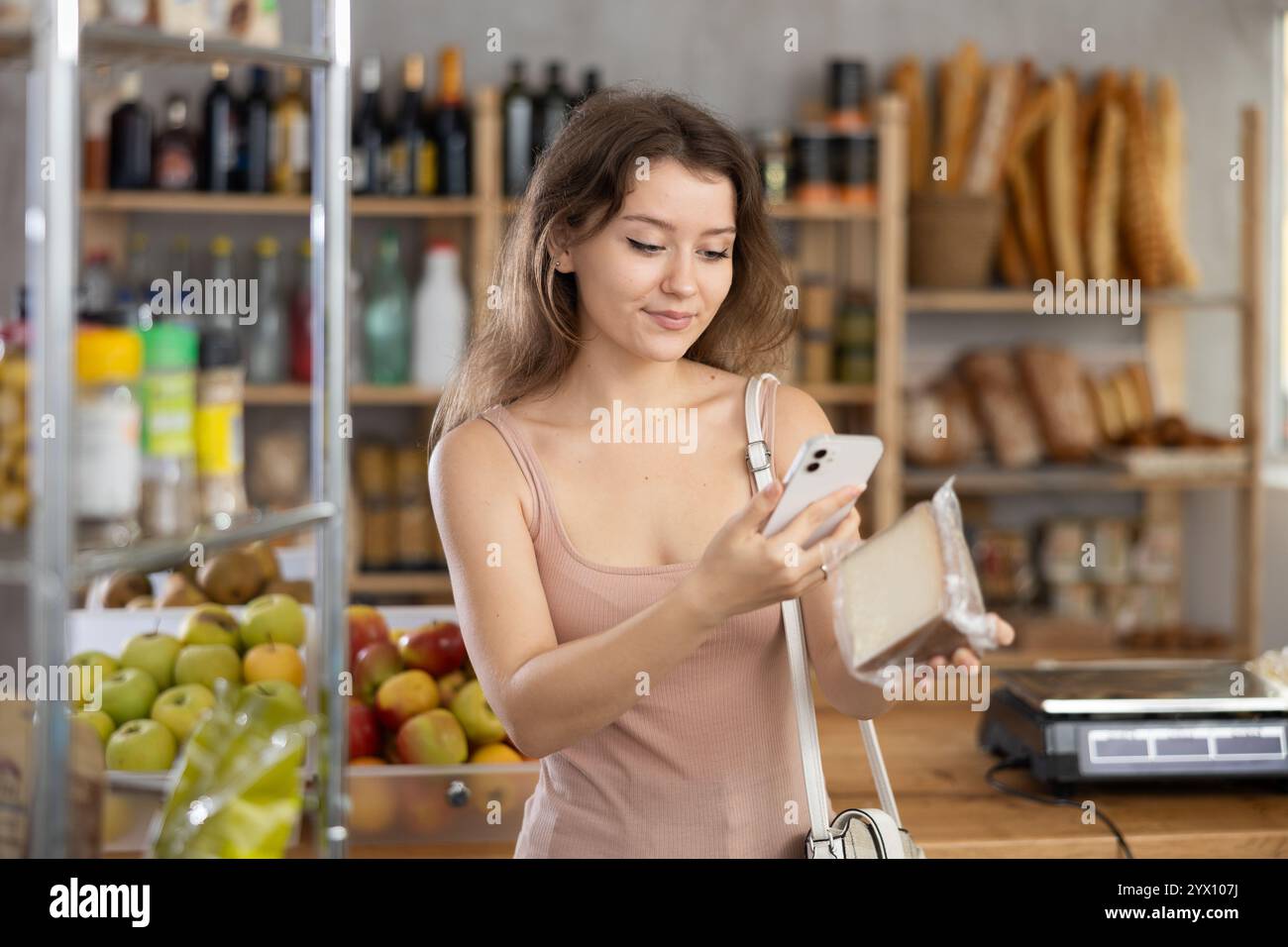 Young woman scanning qr code of cheese Stock Photo - Alamy
