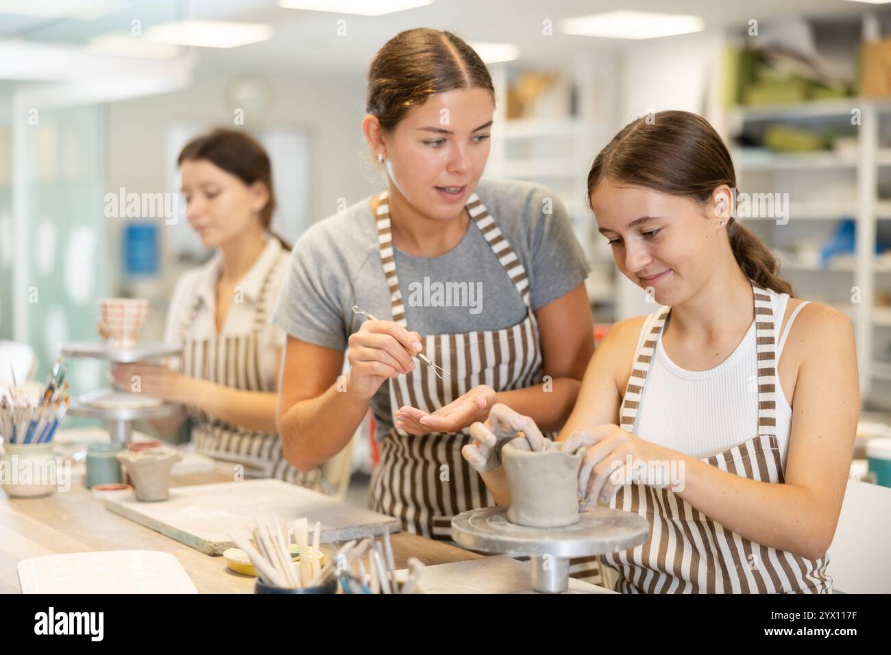 Female teacher explains to student how to make ceramics Stock Photo - Alamy