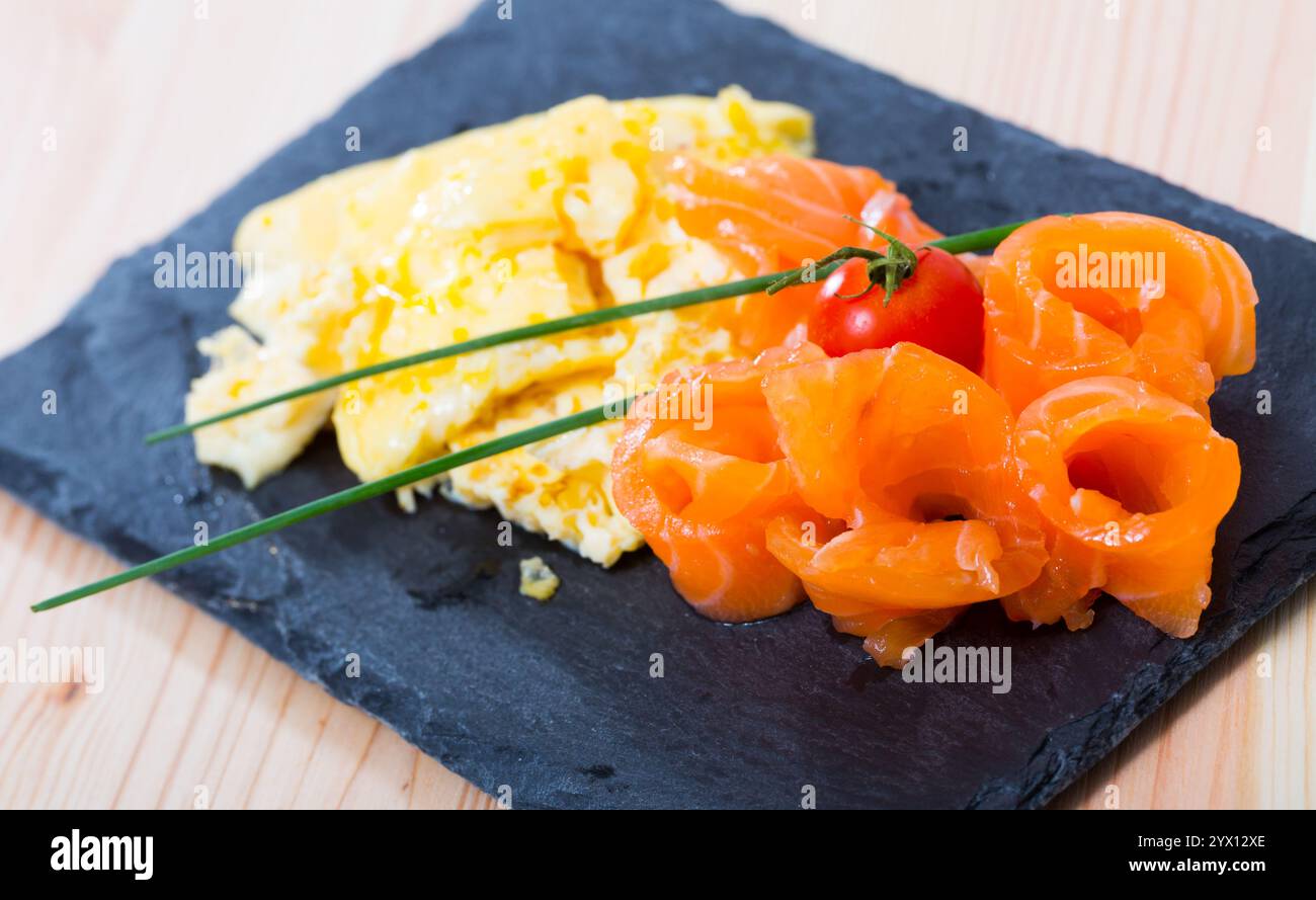Traditional dish of Norwegian cuisine of omelet with salmon at plate ...