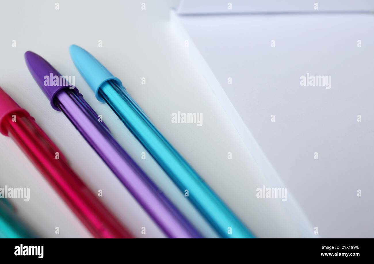 Cool colors ballpoint pen and blank paper notepad with copy space for ...
