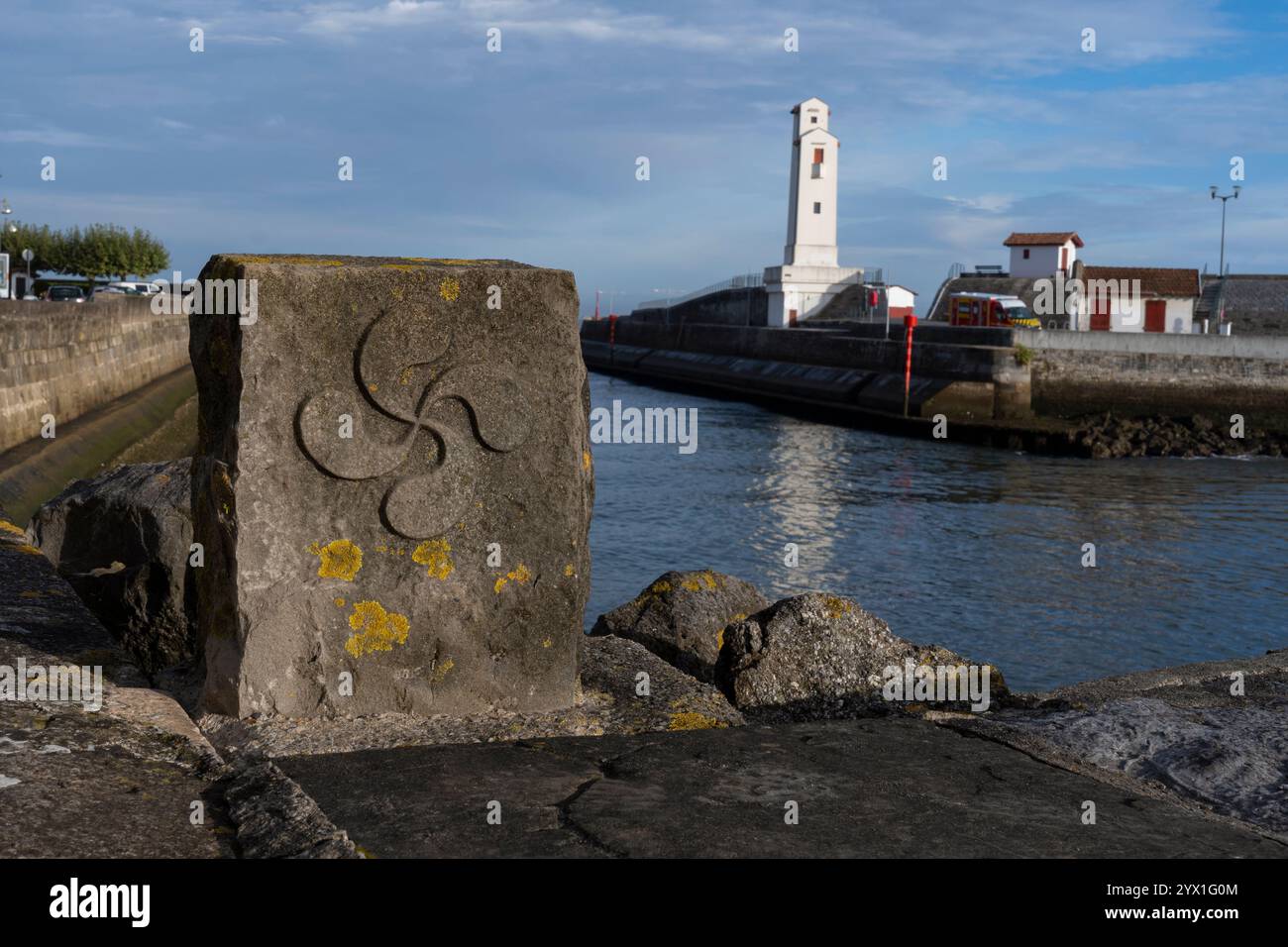 A stone marker with a lauburu, the traditional symbol of the Basque ...