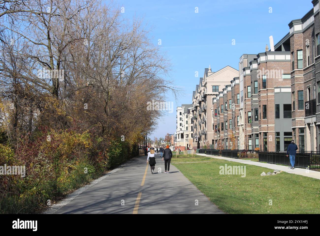 Two women walking on the Monon Greenway Trail next to apartment ...