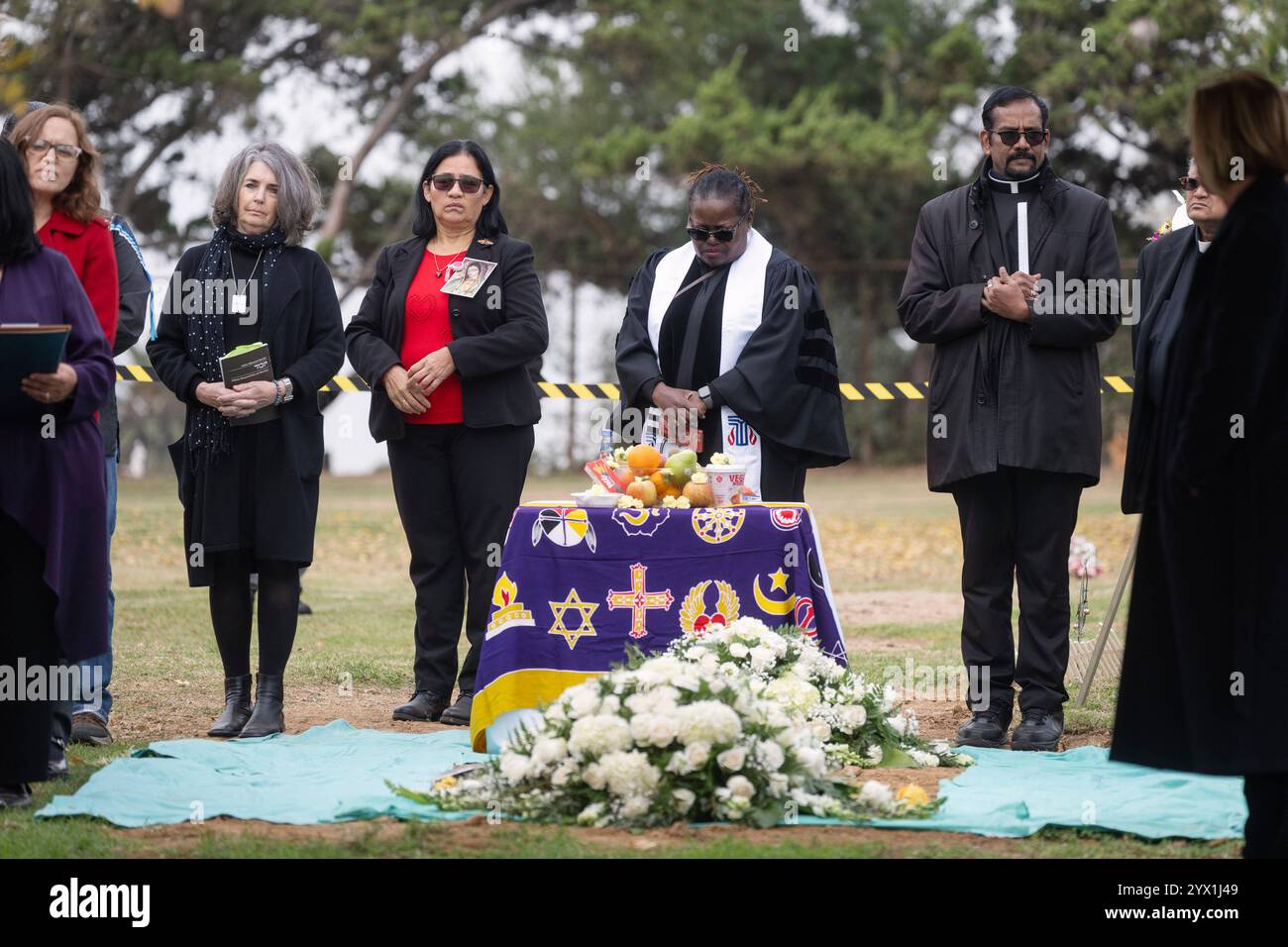 Unclaimed decedents are laid to rest in a single communal grave during ...