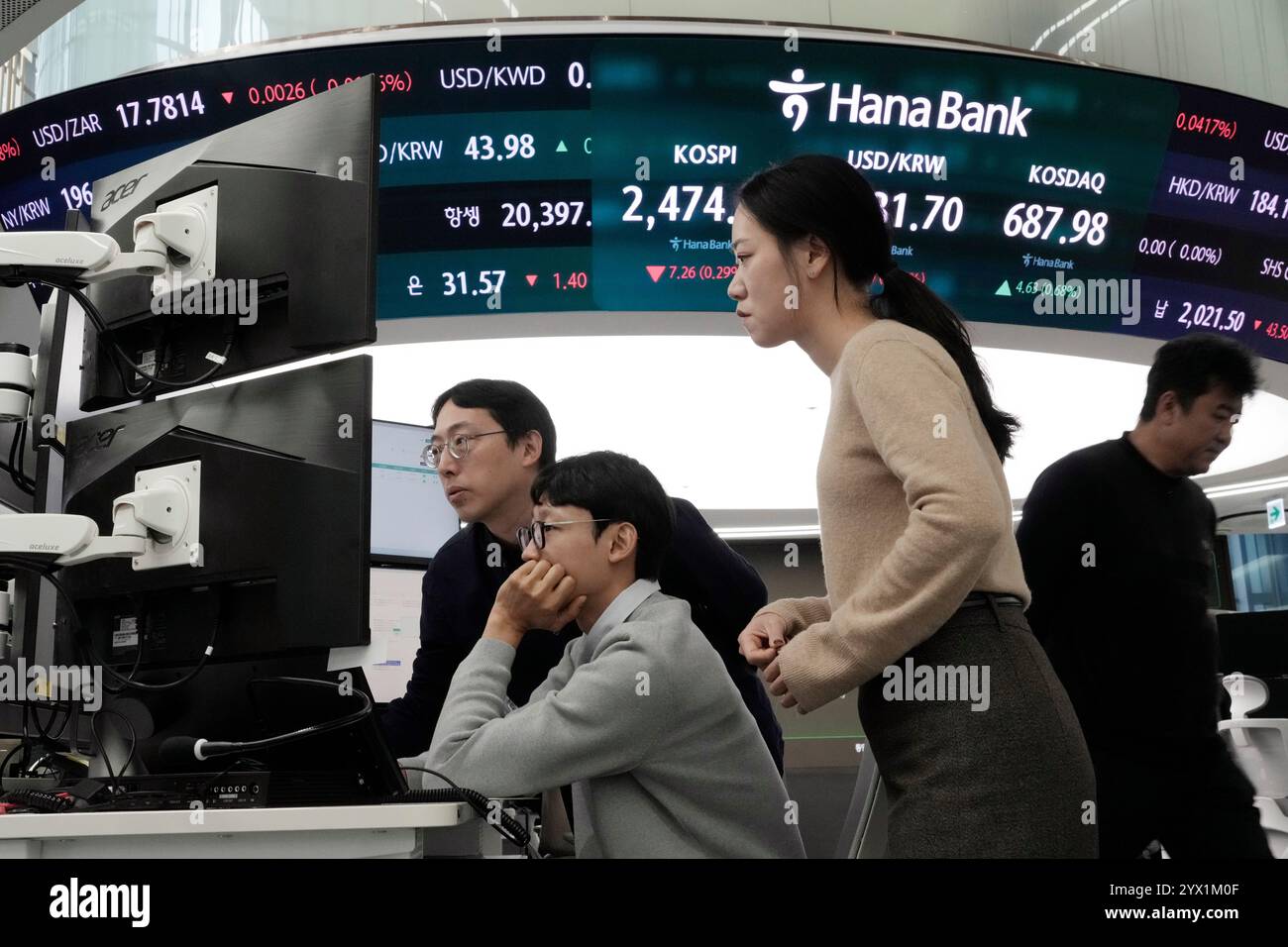 Currency traders watch monitors at the foreign exchange dealing room of ...