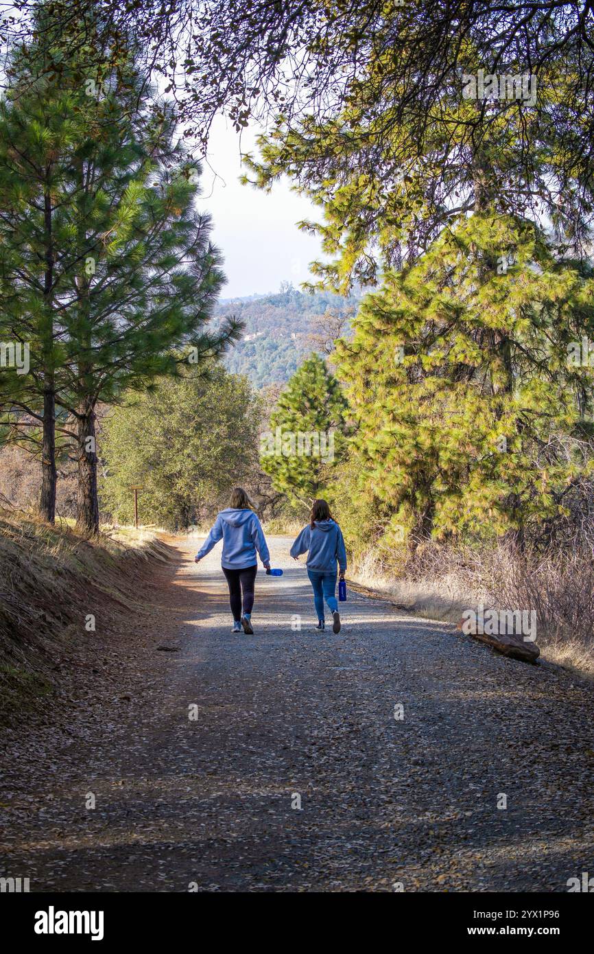 Two people walking on a trail at Hidden Falls Regional Park. The park's ...