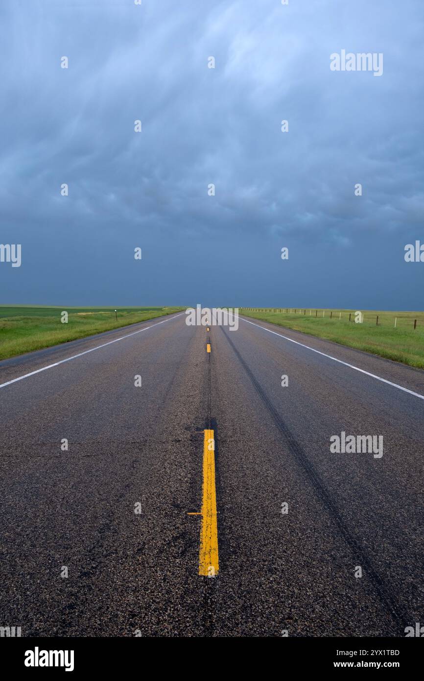 Vertical view of a lonely stretch of highway on the high plains of ...